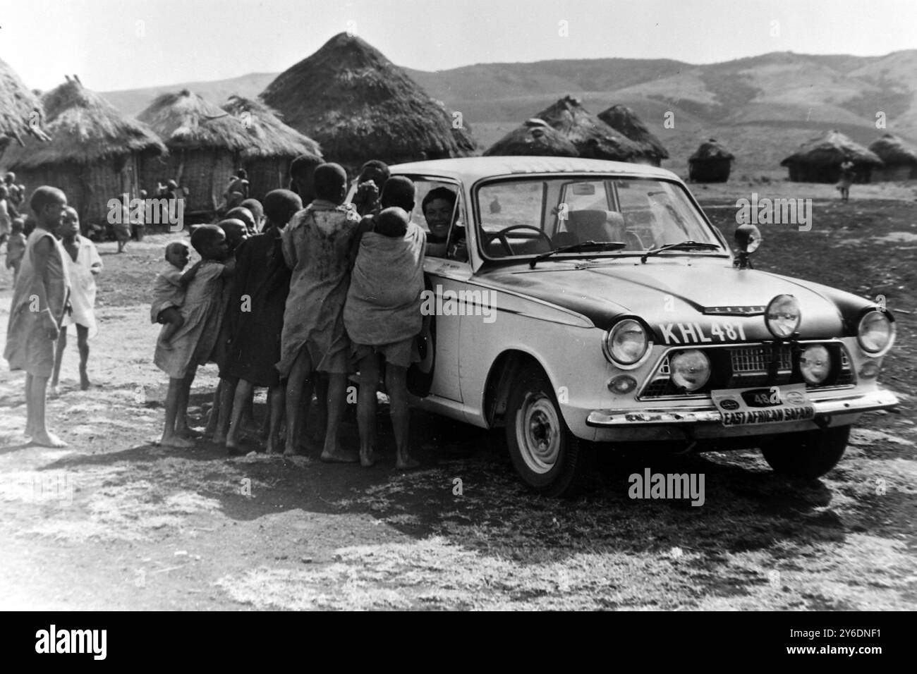MOTOR RALLY EAST AFRICAN SAFARI PAT MOSS AT WHEEL WITH NATIVE CHILDREN ...