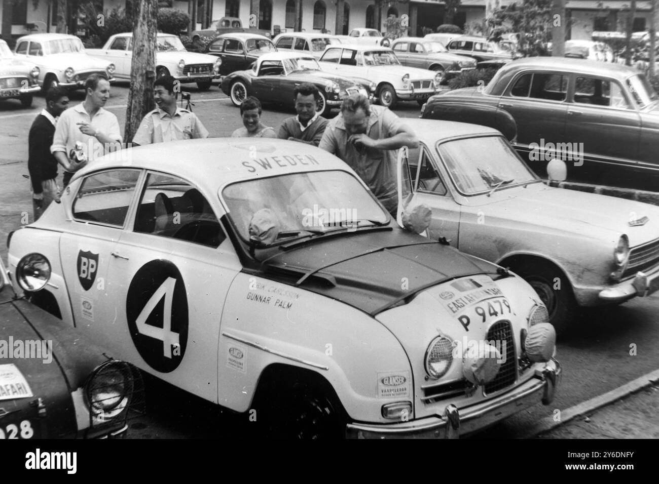 MOTOR RALLY EAST AFRICAN SAFARI ERIK CARLSSON LEANS ON A DOOR SAAB WITH ...