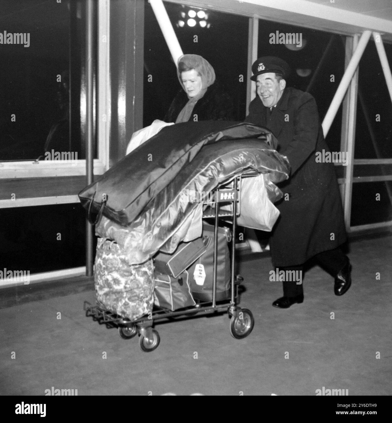 LUGGAGE PORTER PUSHES TROLLEY CARRYING MISS HOPE COOK'S LUGGAGE ; 15 ...