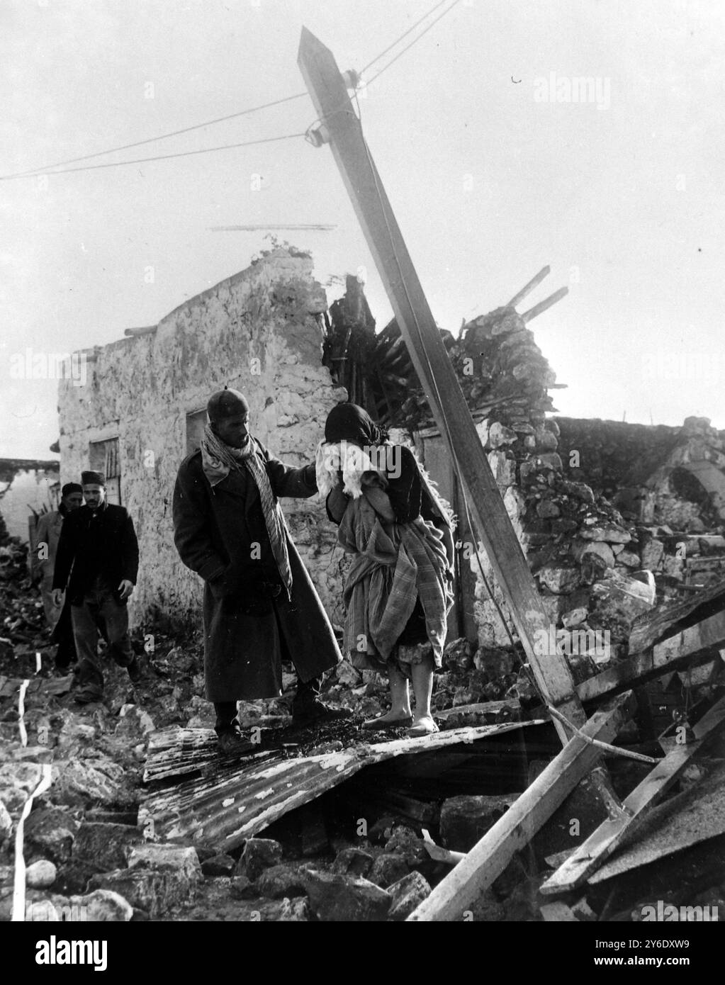 EARTHQUAKE MAN COMFORTS WEEPING WOMAN IN BARCE, LIBYA ; 24 FEBRUARY ...