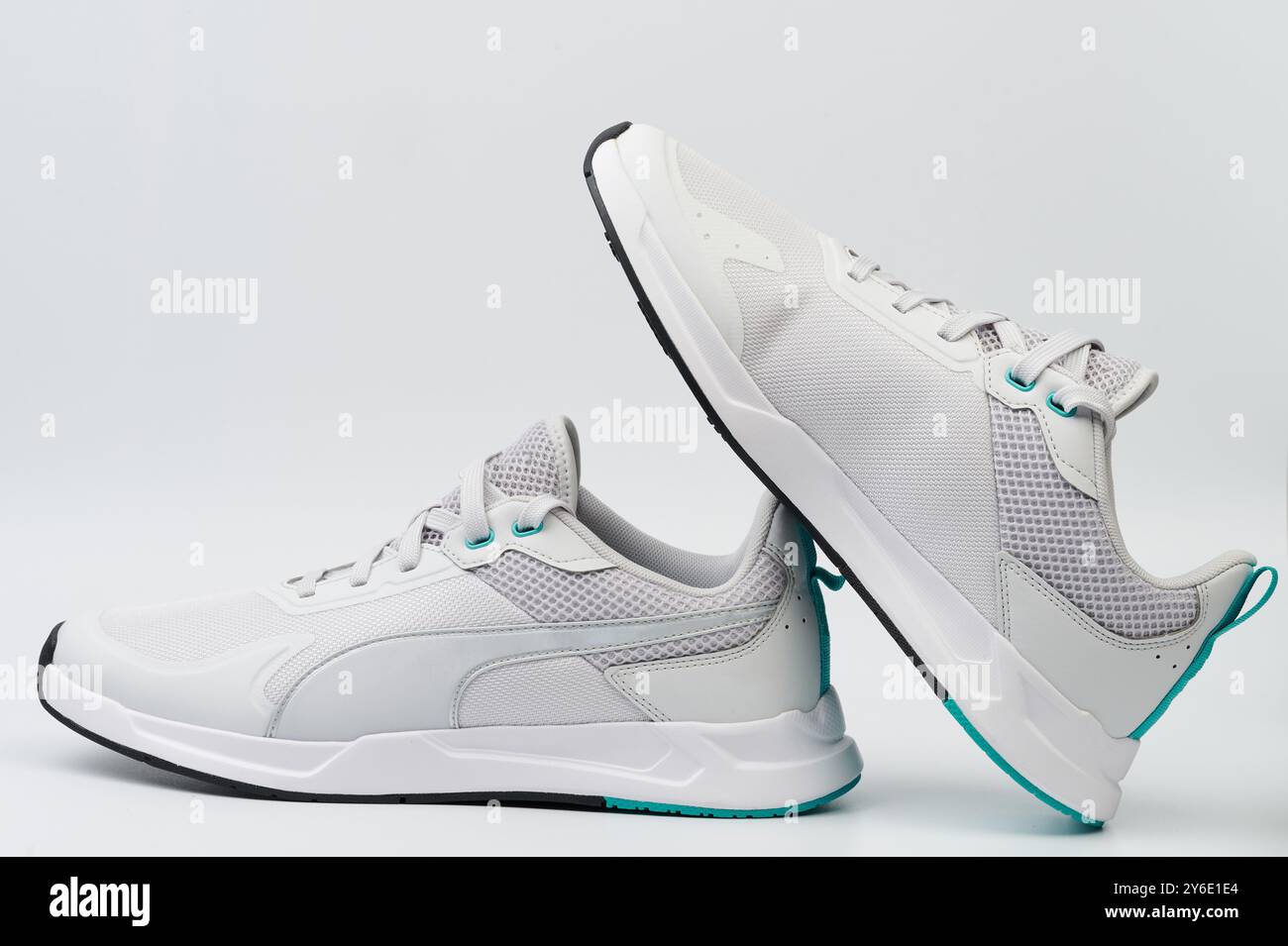 Pair of white sneaker shoes side view isolated on studio background ...