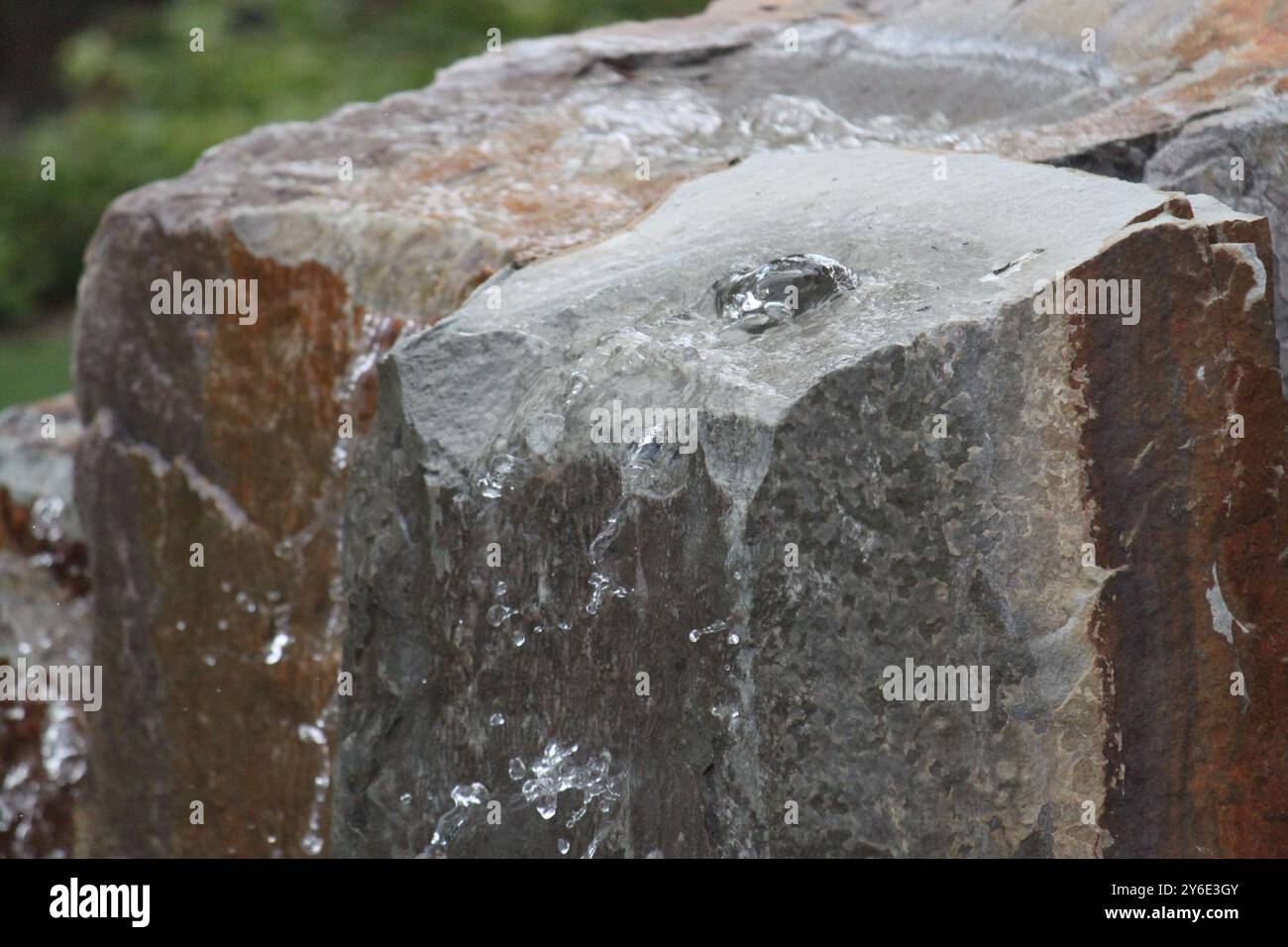 rocks with a waterfall outside in a backyard very pretty and unique ...