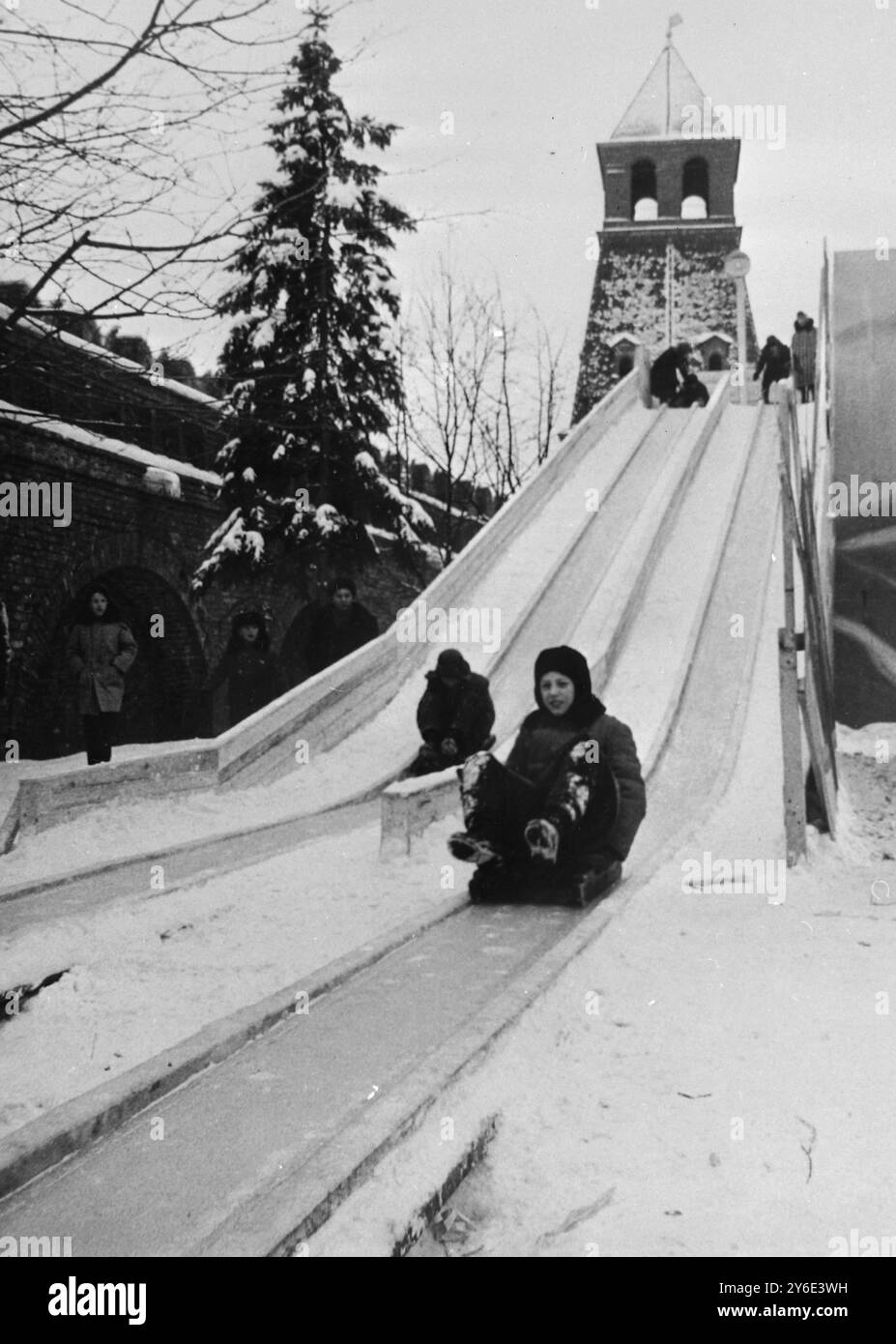 CHILDREN PLAYING IN FROZEN PLAYGROUND IN MOSCOW ; 21 JANUARY 1963 Stock ...