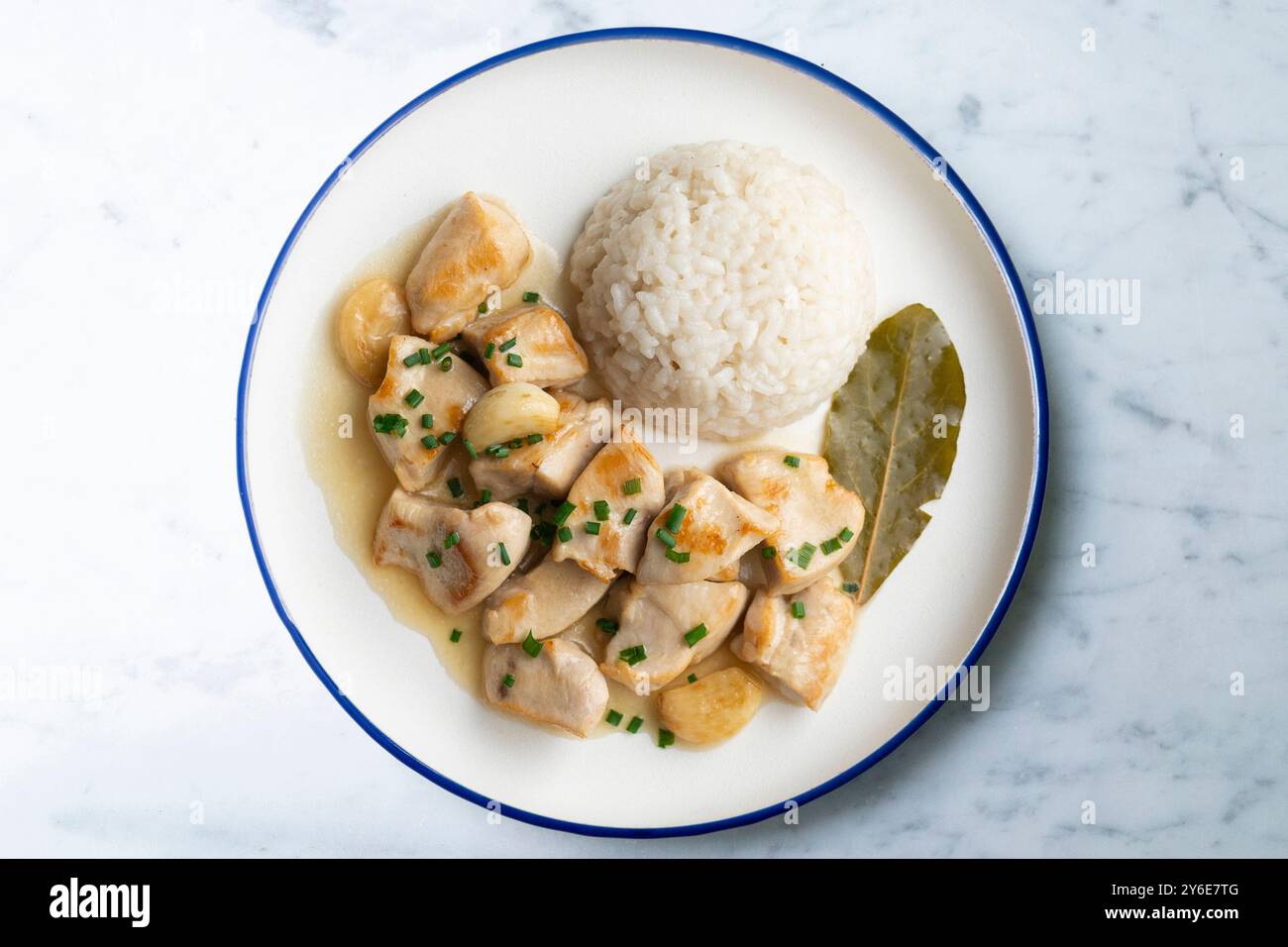 Garlic chicken with bay leaf aroma and white rice. Top view table with ...