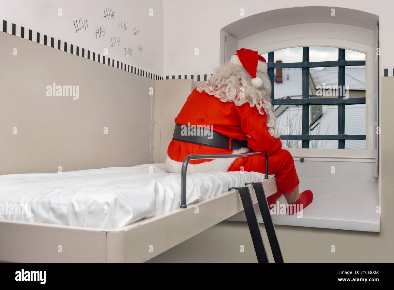 A dejected Santa Claus looks out of a prison window Stock Photo - Alamy