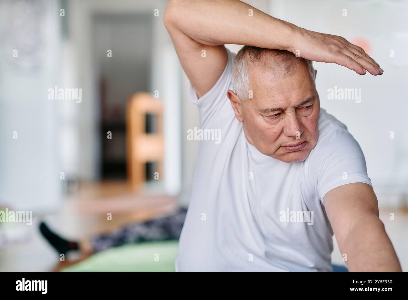 Senior Man Performing Neck and Back Exercises to Promote Healthy Aging ...