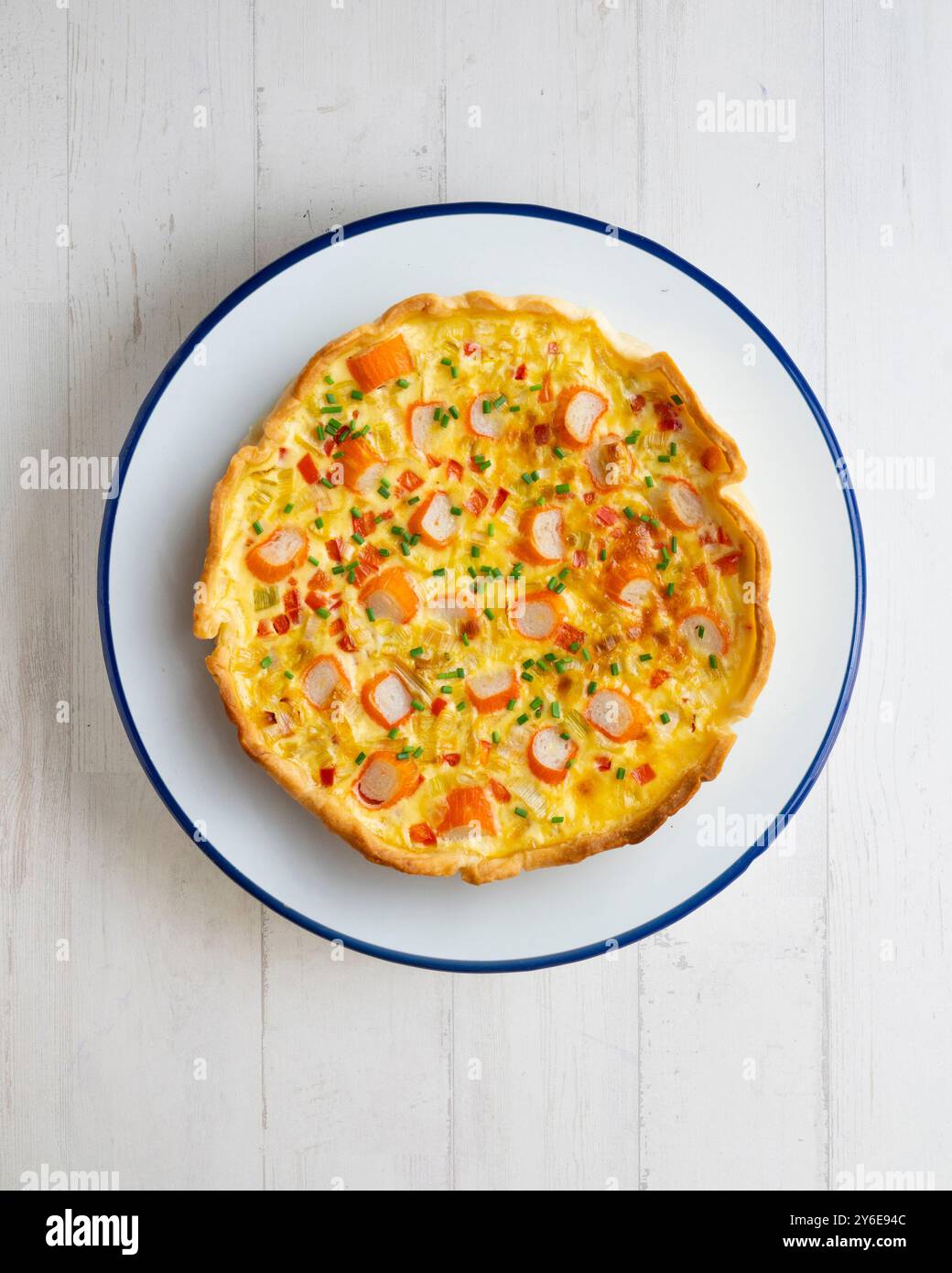 Individual quiche with vegetables and crab surimi. Top view table with ...