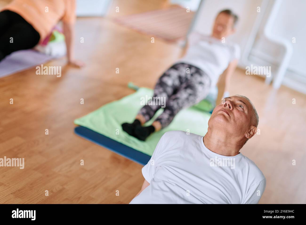 Senior Man Performing Neck and Back Exercises to Promote Healthy Aging ...