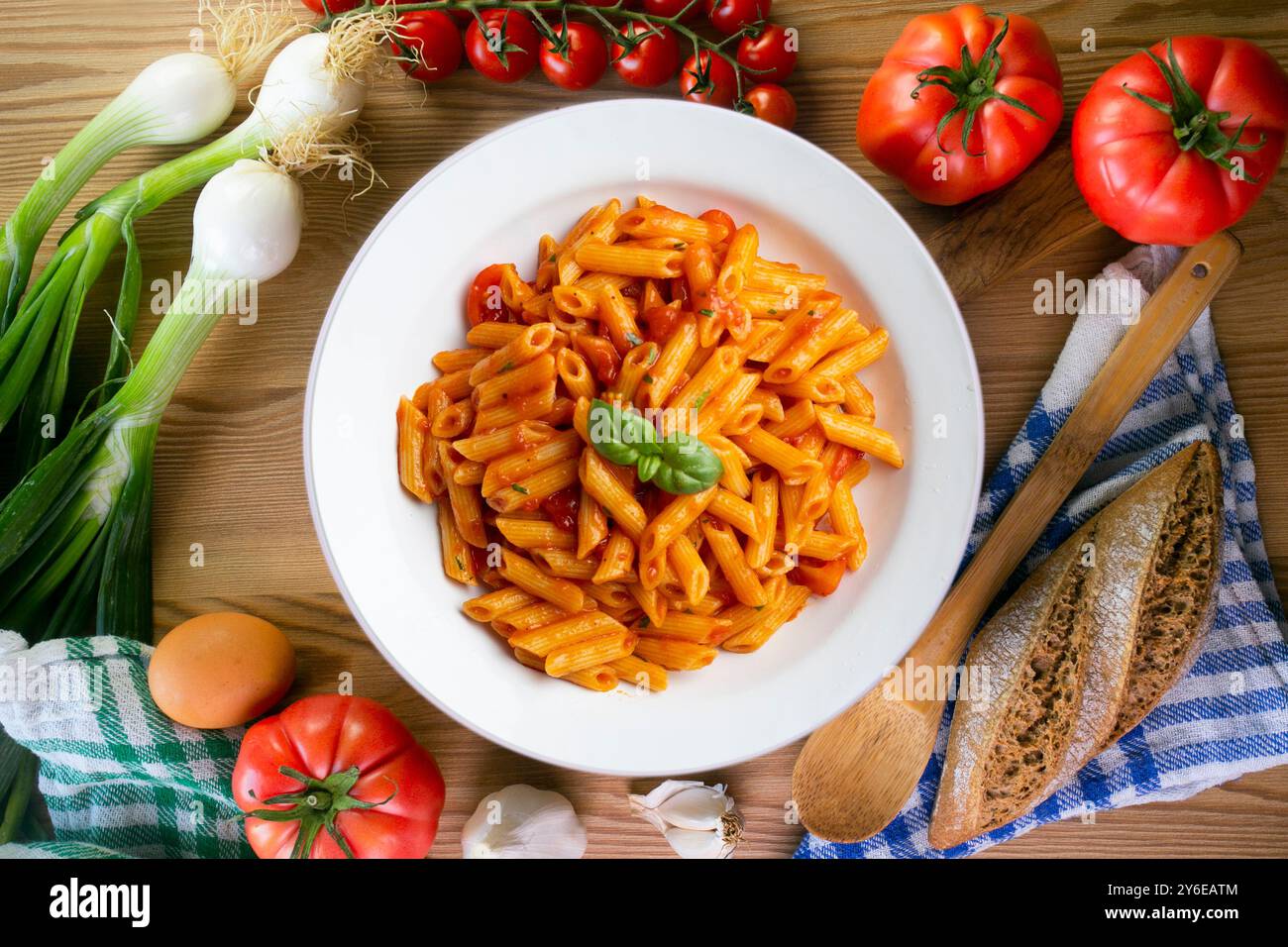 Macaroni with tomato and basil aroma. Top view table with decorations ...