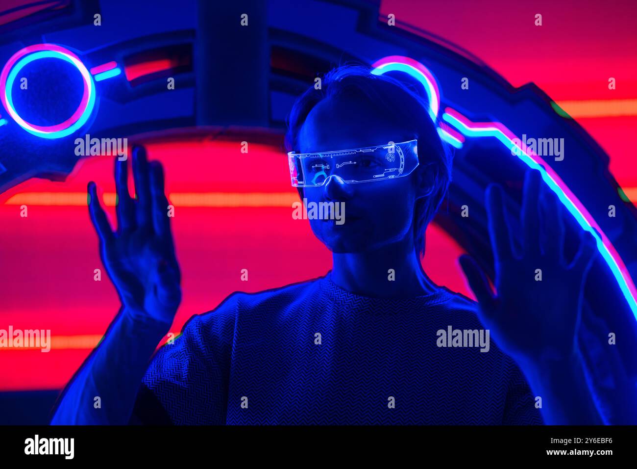 Creative futuristic man with smart neon glasses in a neon room a neon ...