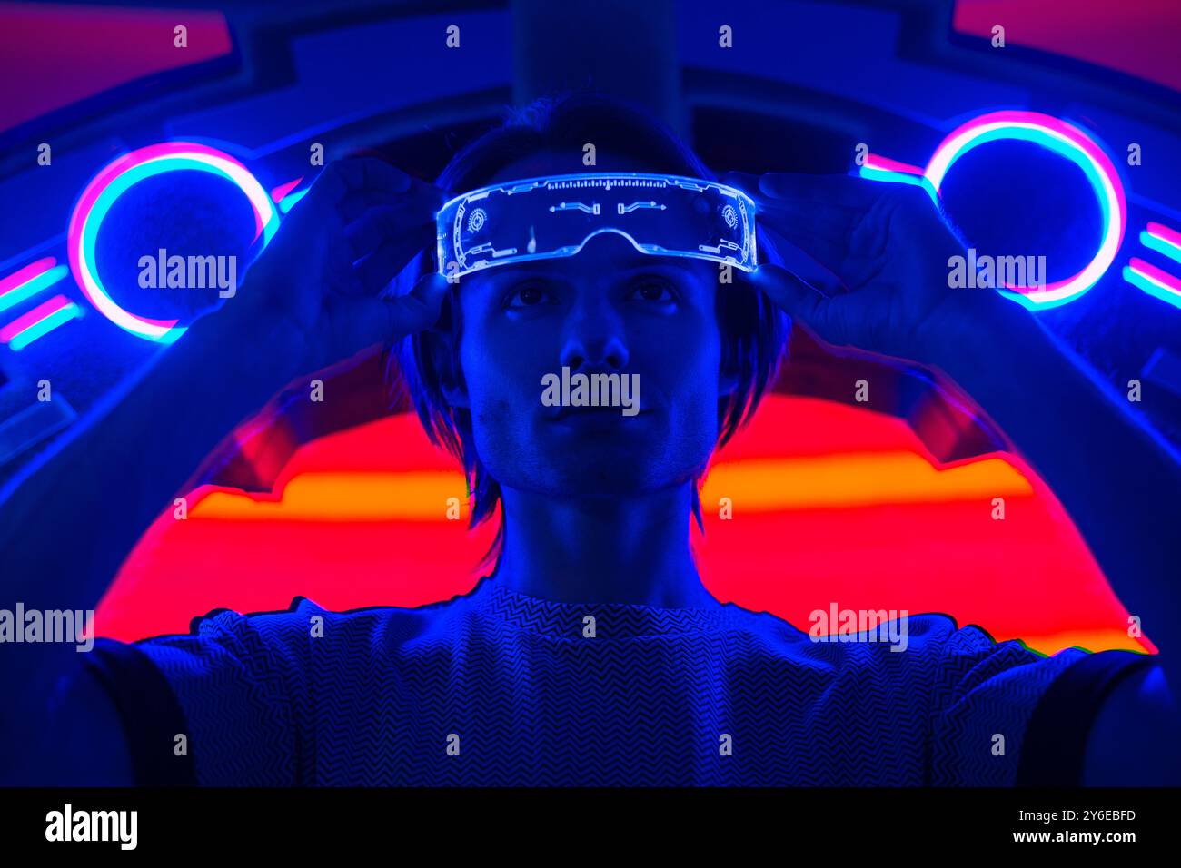 Creative futuristic man with smart neon glasses in a neon room a neon ...
