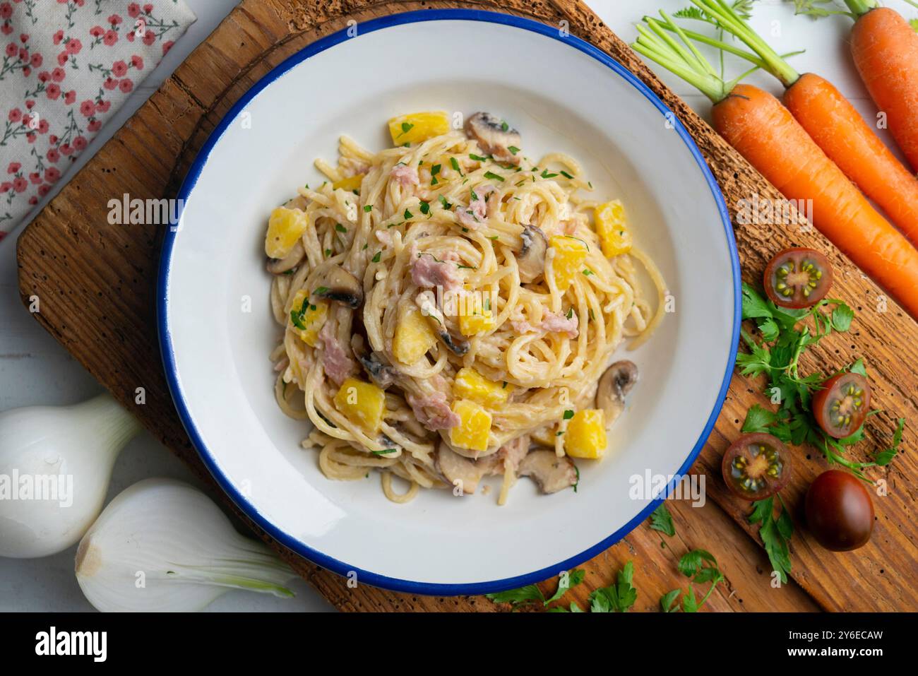 Spaghetti with pineapple, ham and cream sauce. Top view table with ...