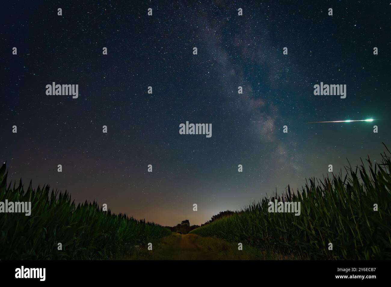 Glowing green meteor crosses the Milky Way above a cornfield Stock ...