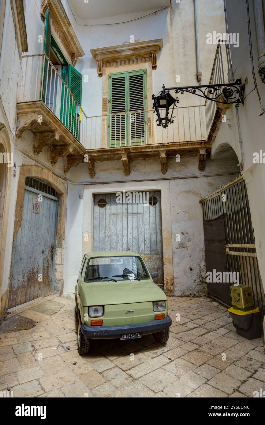 vintage retro Fiat 126 green fade paintwork parked in small courtyard ...