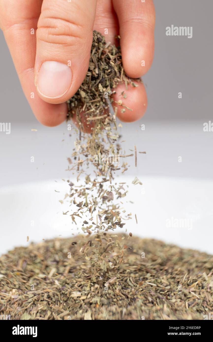 Hand pouring dried chopped hi-res stock photography and images - Alamy