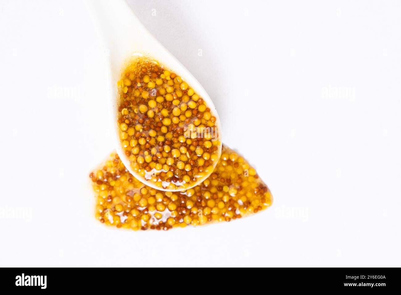 Traditional French Dijon mustard in a spoon on a white background Stock ...