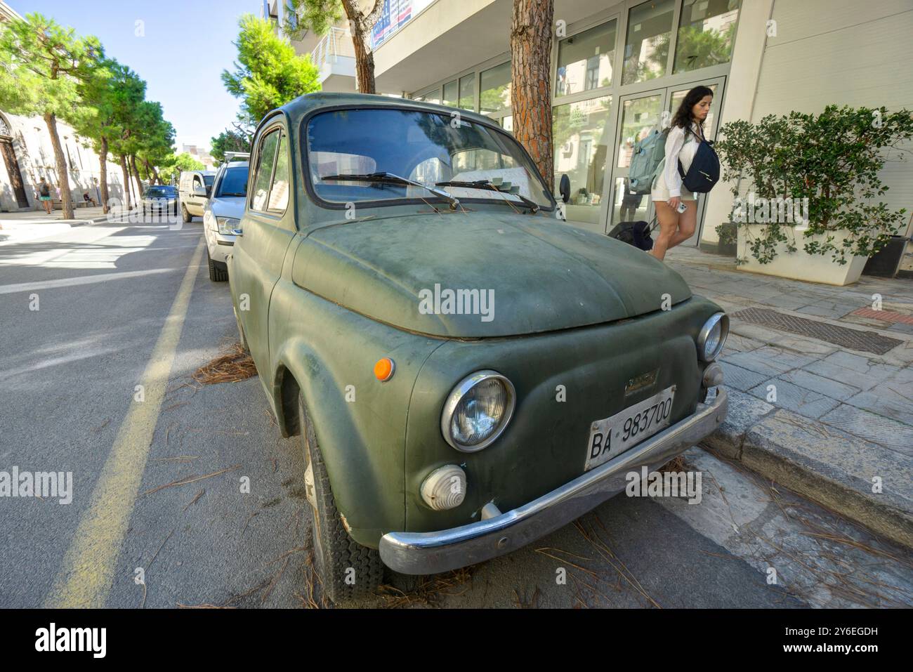 faded green vintage Fiat 500 bubble car parked in street in polignano a ...