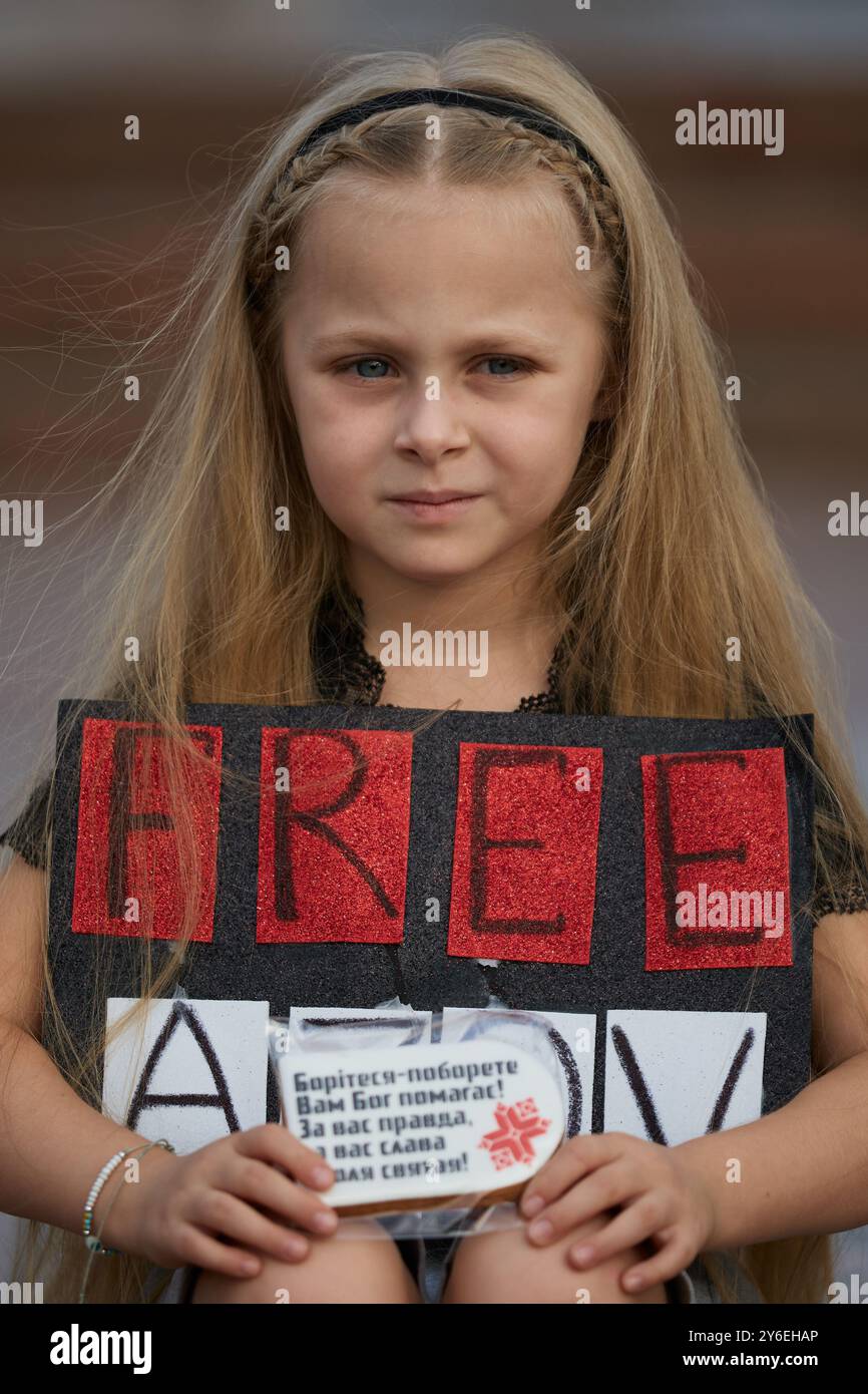 Little Ukrainian girl demonstrating with a banner Free Azov at public ...