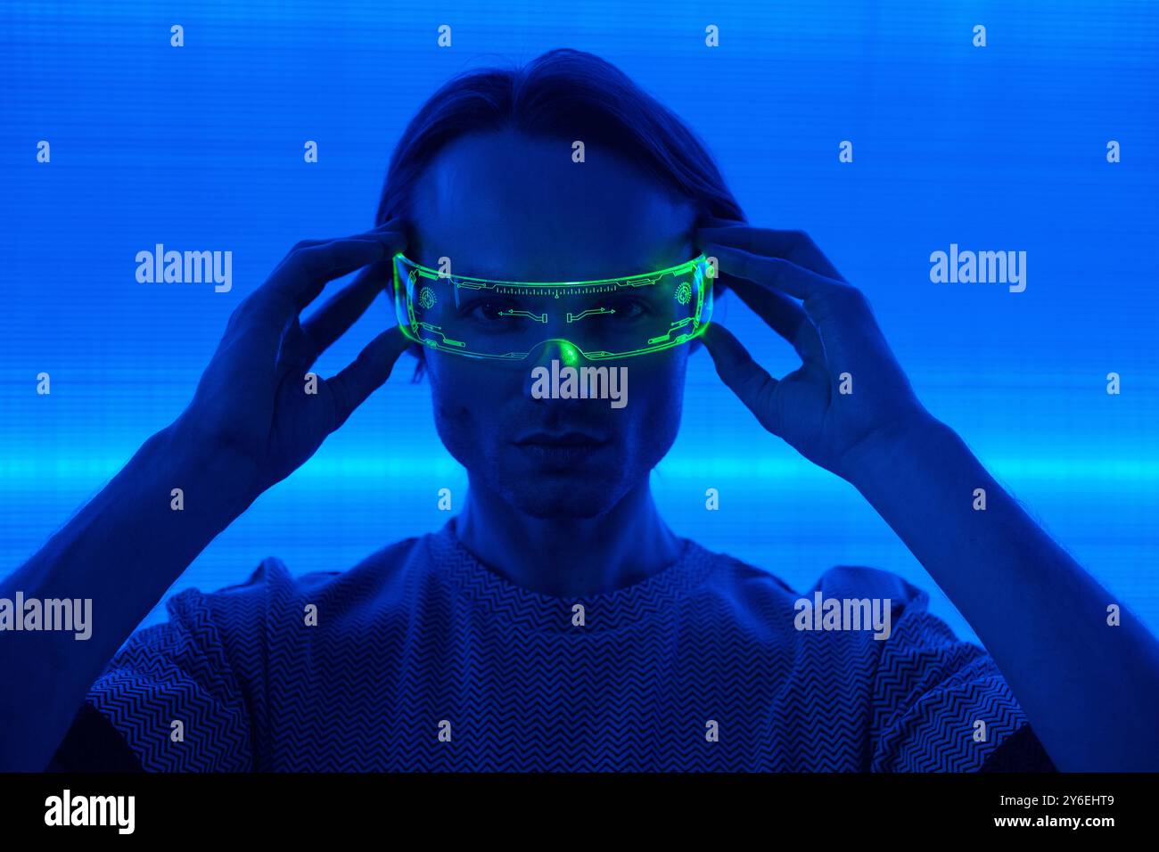 Creative futuristic man with smart neon glasses in a neon room a neon ...