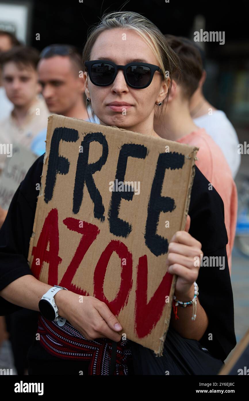 Ukrainian activist posing with a sign Free Azov outdoors. Kyiv - 15 ...