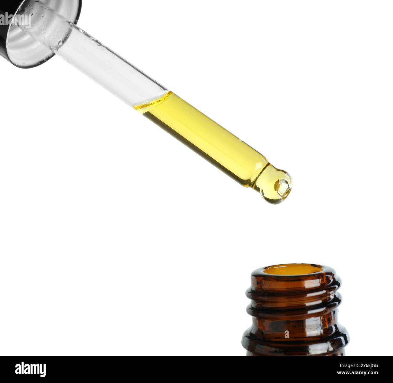 Dripping tincture from pipette into bottle against white background ...