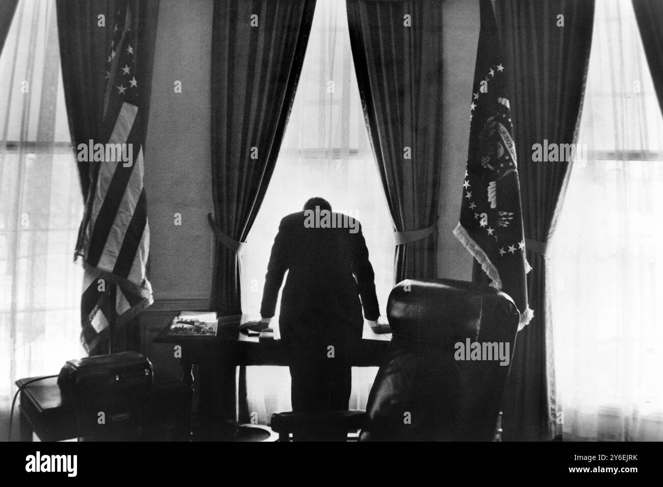 AMERICAN PRESIDENT JOHN F KENNEDY LEANS OVER HIS DESK IN THE WHITE ...