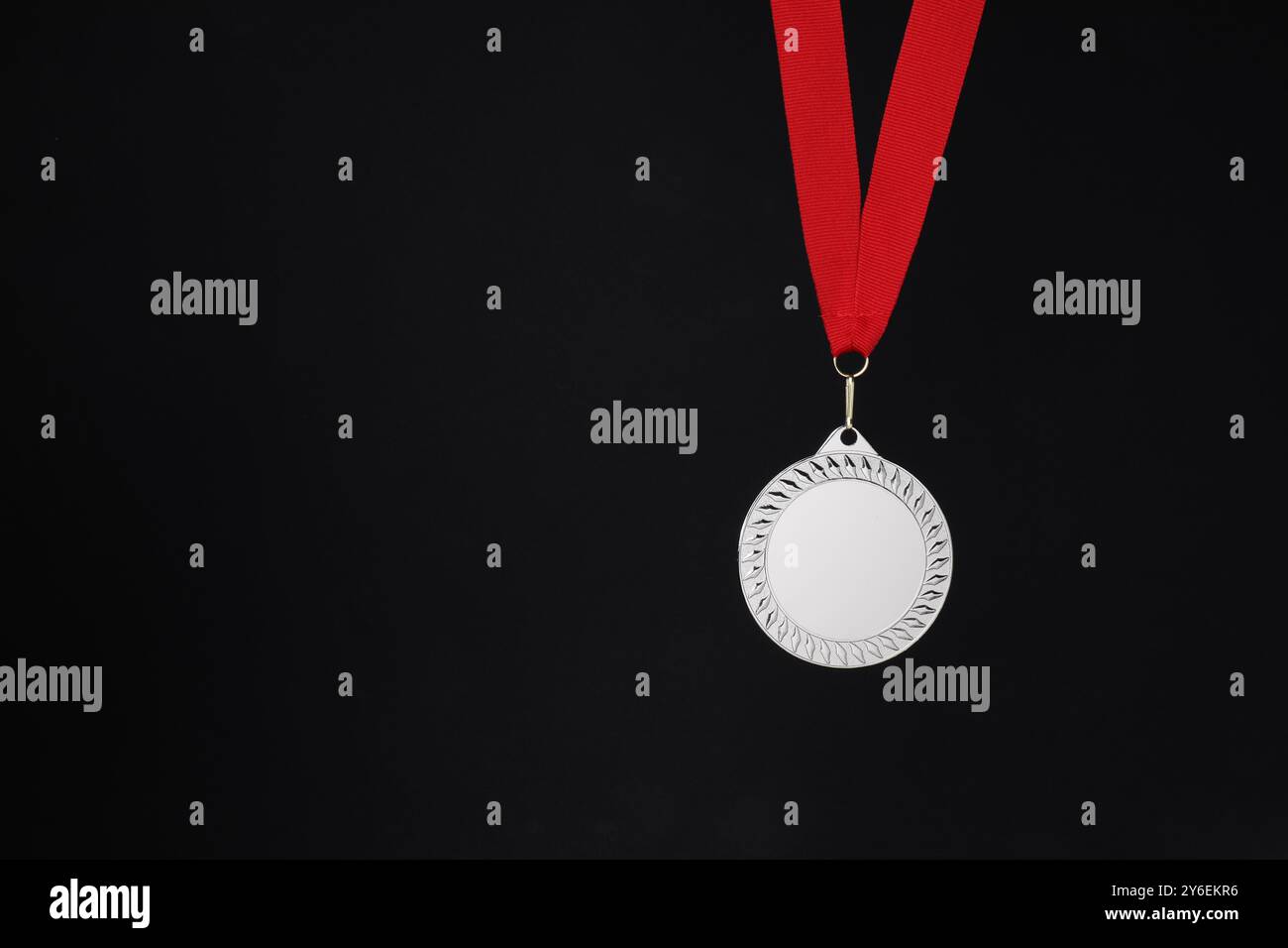 Silver medal with red ribbon on black background, space for text Stock ...