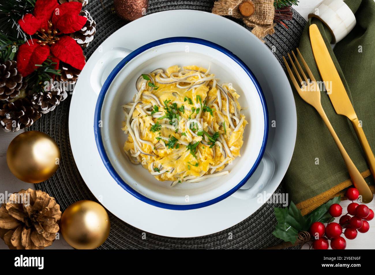 Scrambled eggs with baby eels and garlic. Top view table with Christmas ...