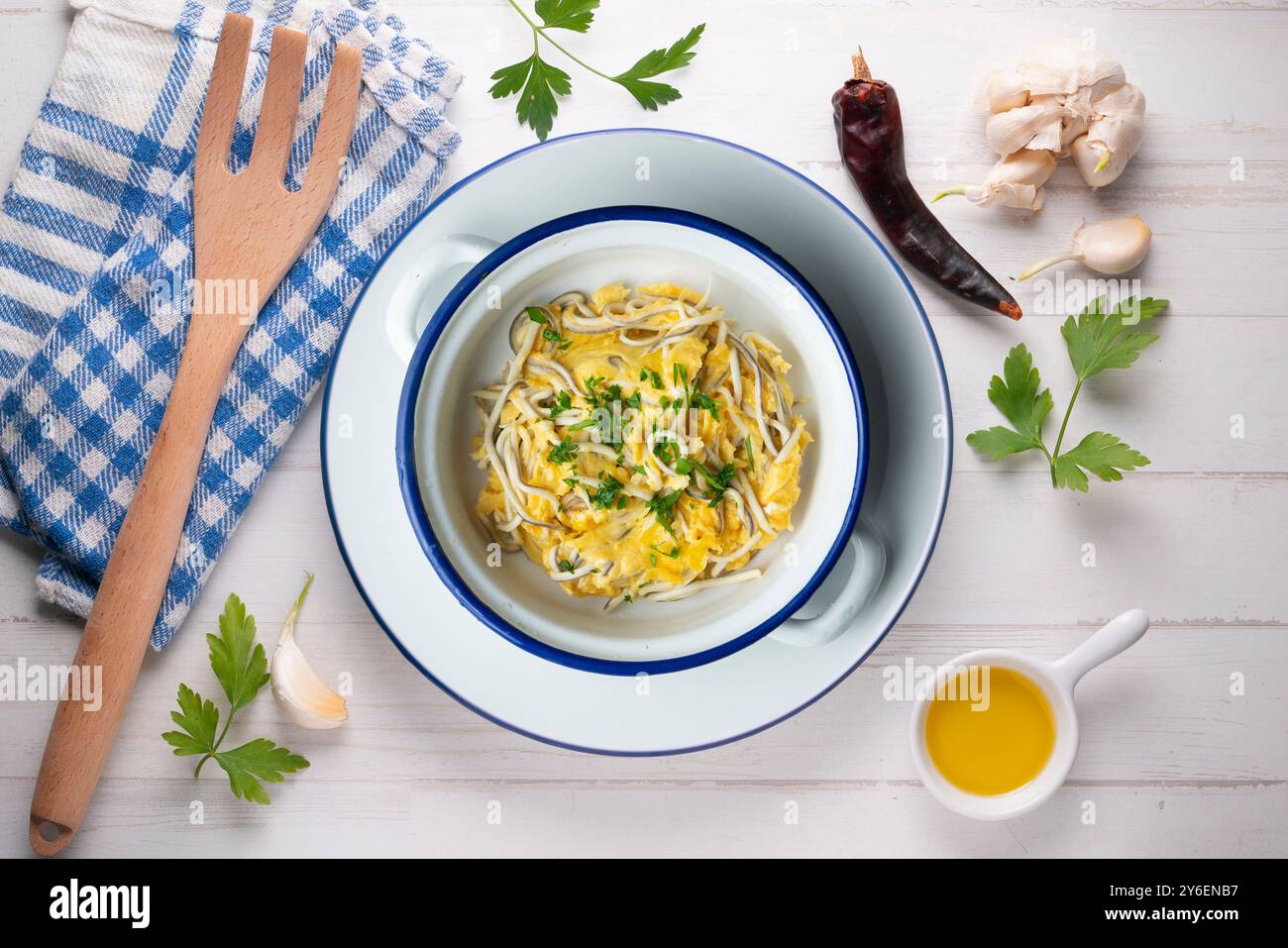 Scrambled eggs with baby eels and garlic. Top view table with ...