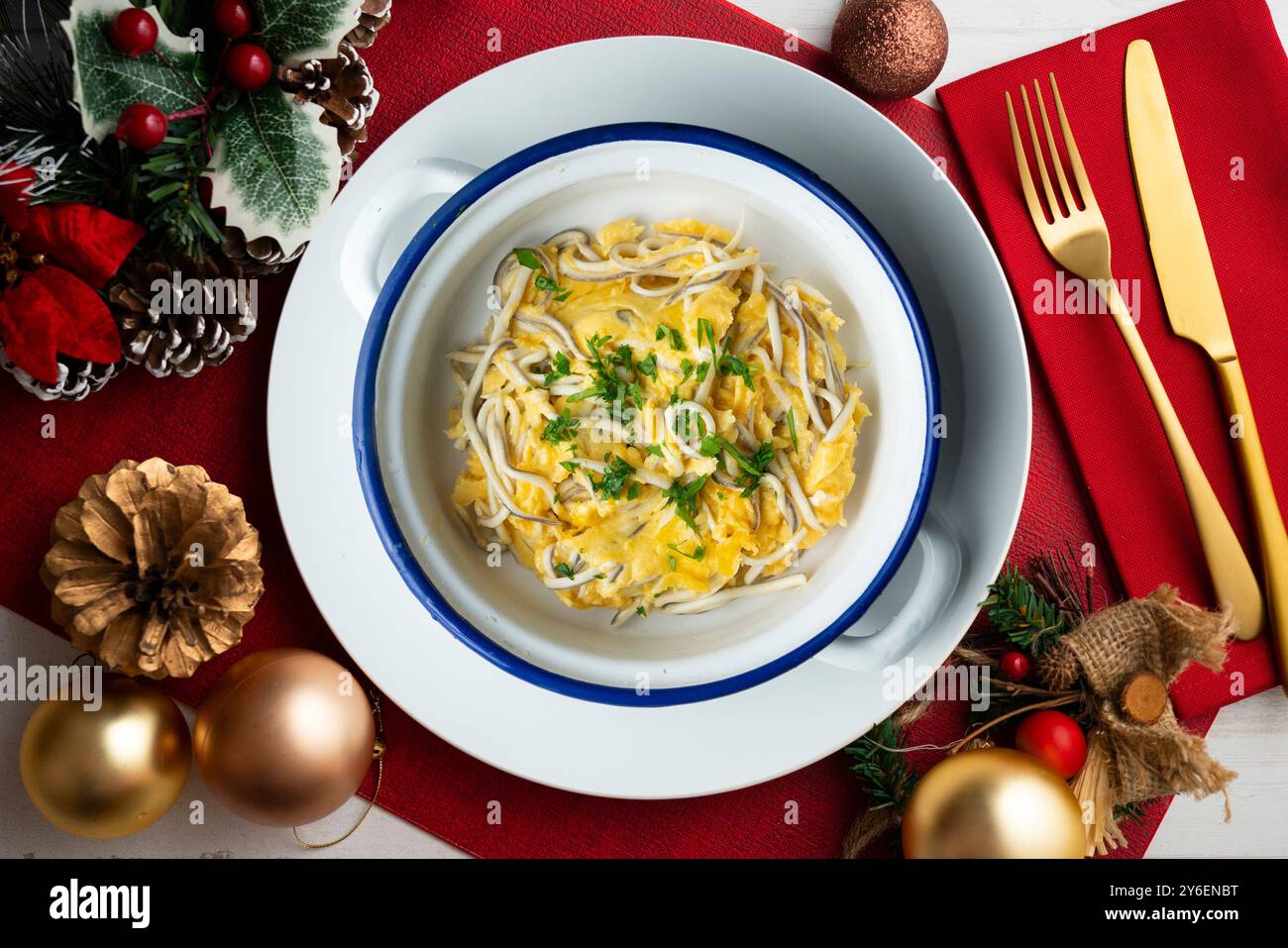 Scrambled eggs with baby eels and garlic. Top view table with Christmas ...