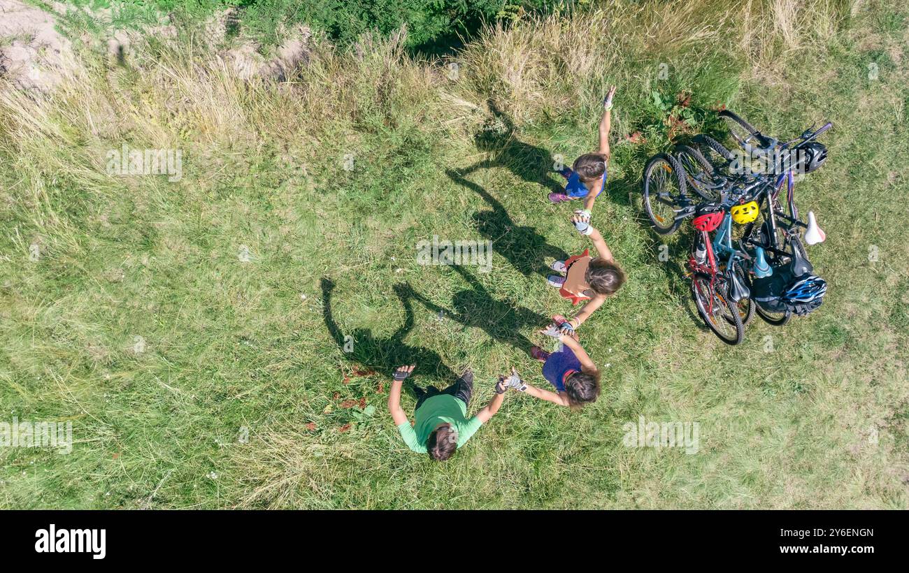 Family on bikes cycling outdoors, active parents and kids on bicycles ...