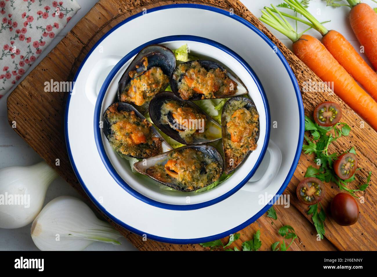 Mussels au gratin with parsley, oil and bread. Top view table with ...