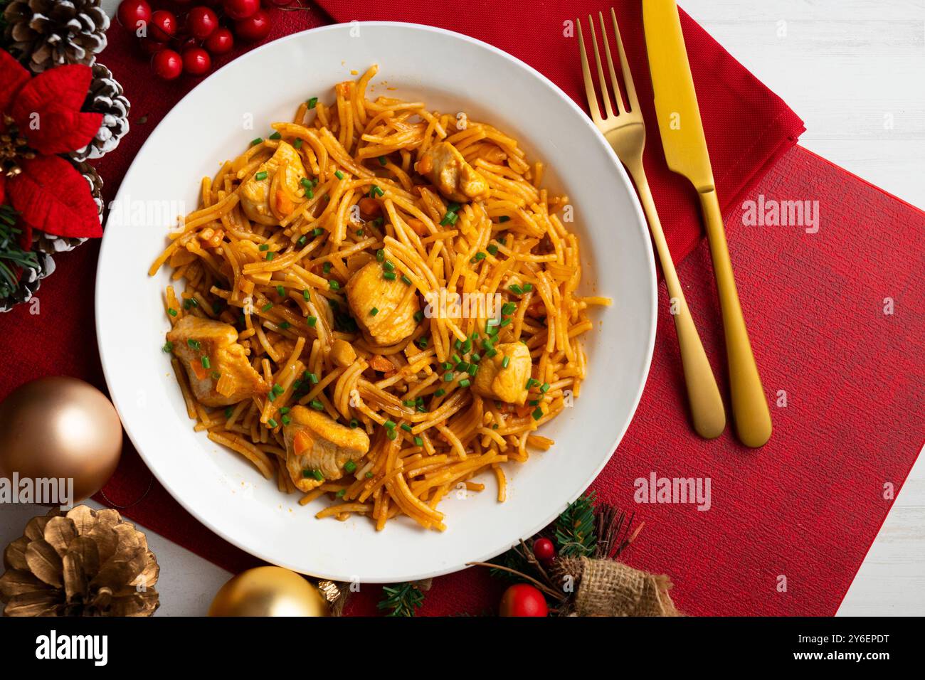 Spanish paella with fideuá and vegetables and chicken. Top view table ...