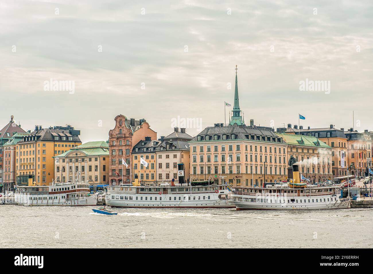 Tour boats at Skeppsbron waterfront of the Old Town of Stockholm. The ...