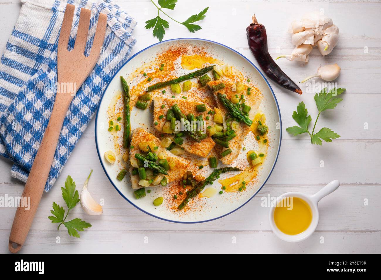 Grilled swordfish with green asparagus. Top view table with decorations ...
