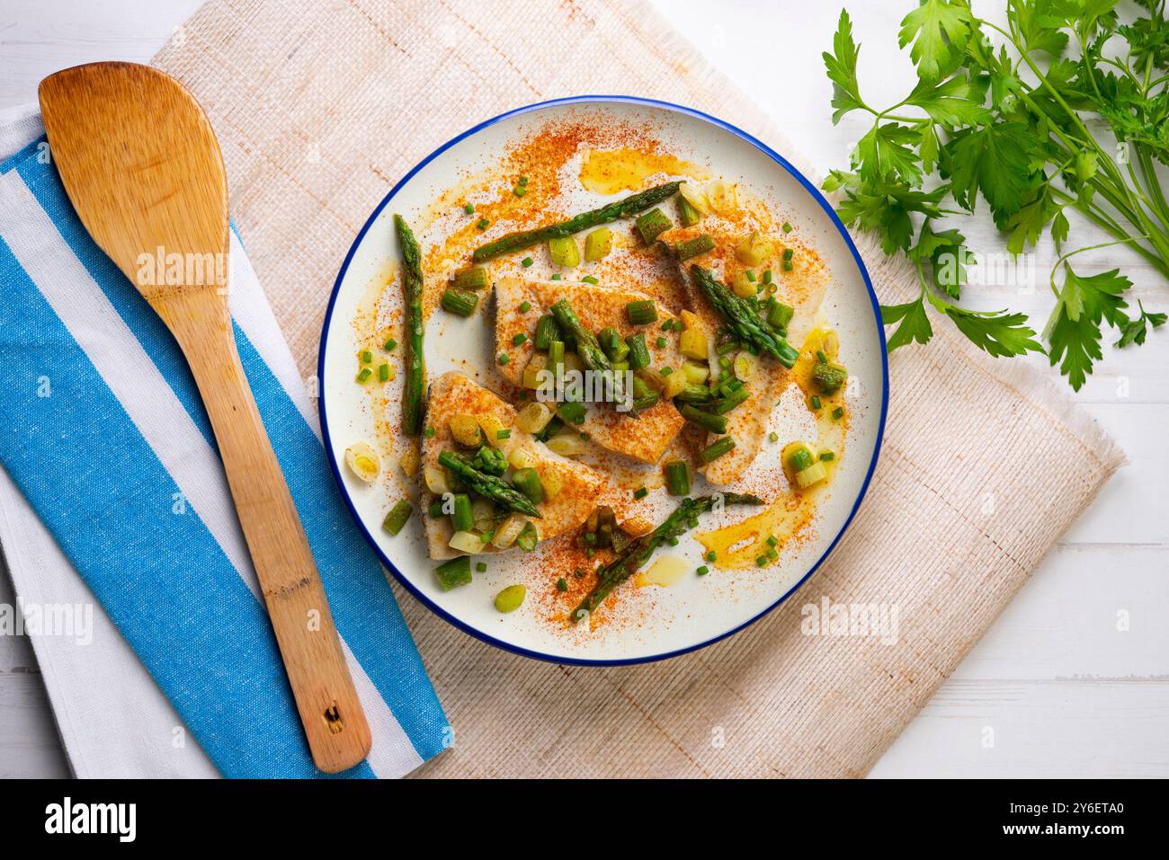 Grilled swordfish with green asparagus. Top view table with decorations ...