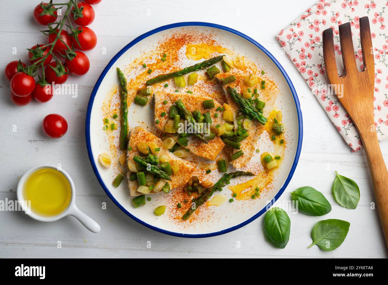 Grilled swordfish with green asparagus. Top view table with decorations ...