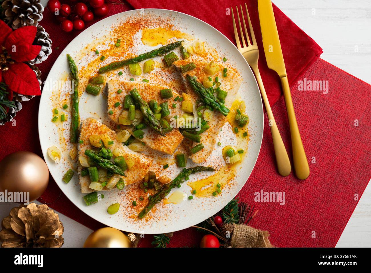 Grilled swordfish with green asparagus. Top view table with Christmas ...