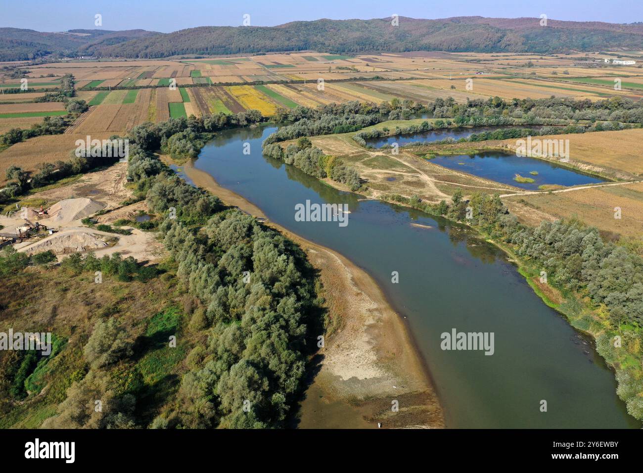 Aerial view of gravel pit mining reservoir and river, ballast ...