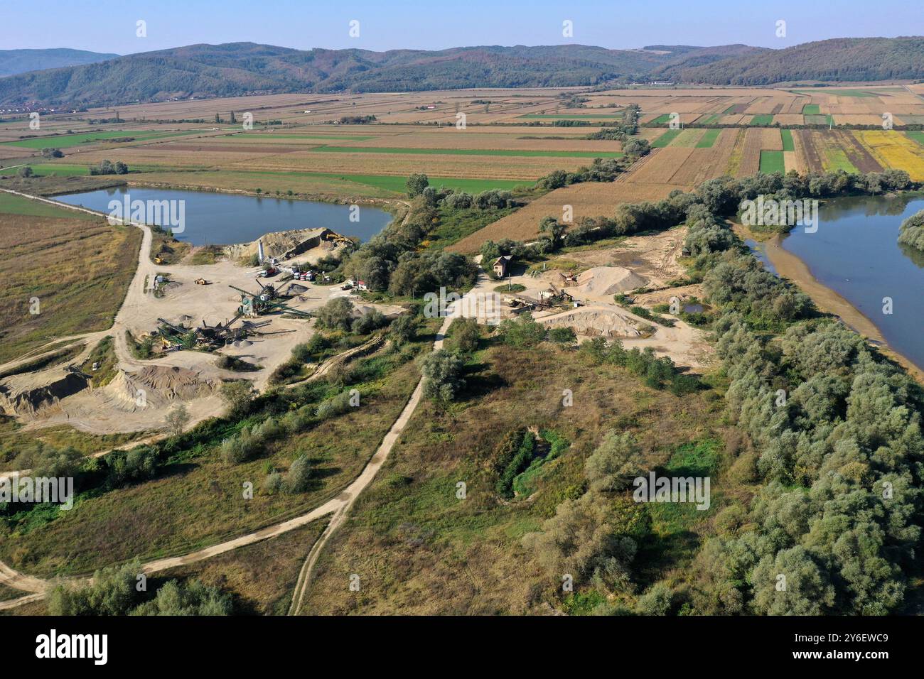 Aerial view of gravel pit mining reservoir and river, ballast ...