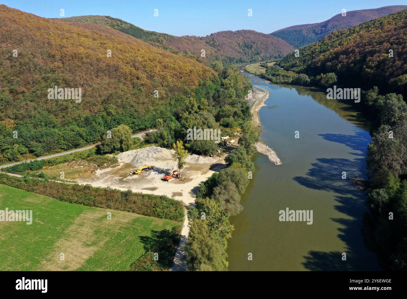 Aerial view of gravel pit mining reservoir and river, ballast ...