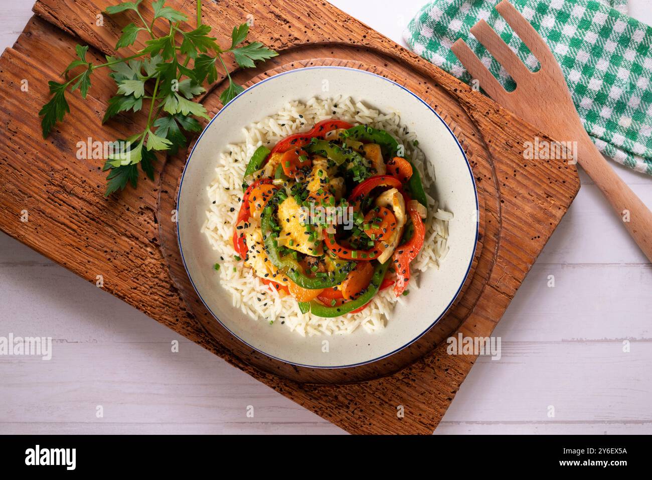 Wok of chicken strips with peppers and rice. Top view table with ...