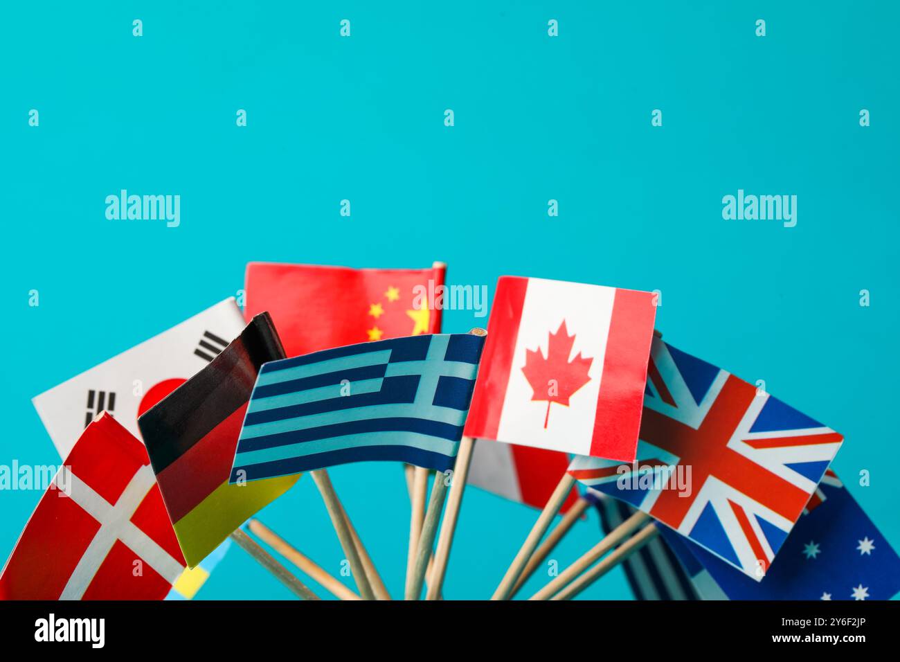 Small paper flags of different countries on light blue background Stock ...