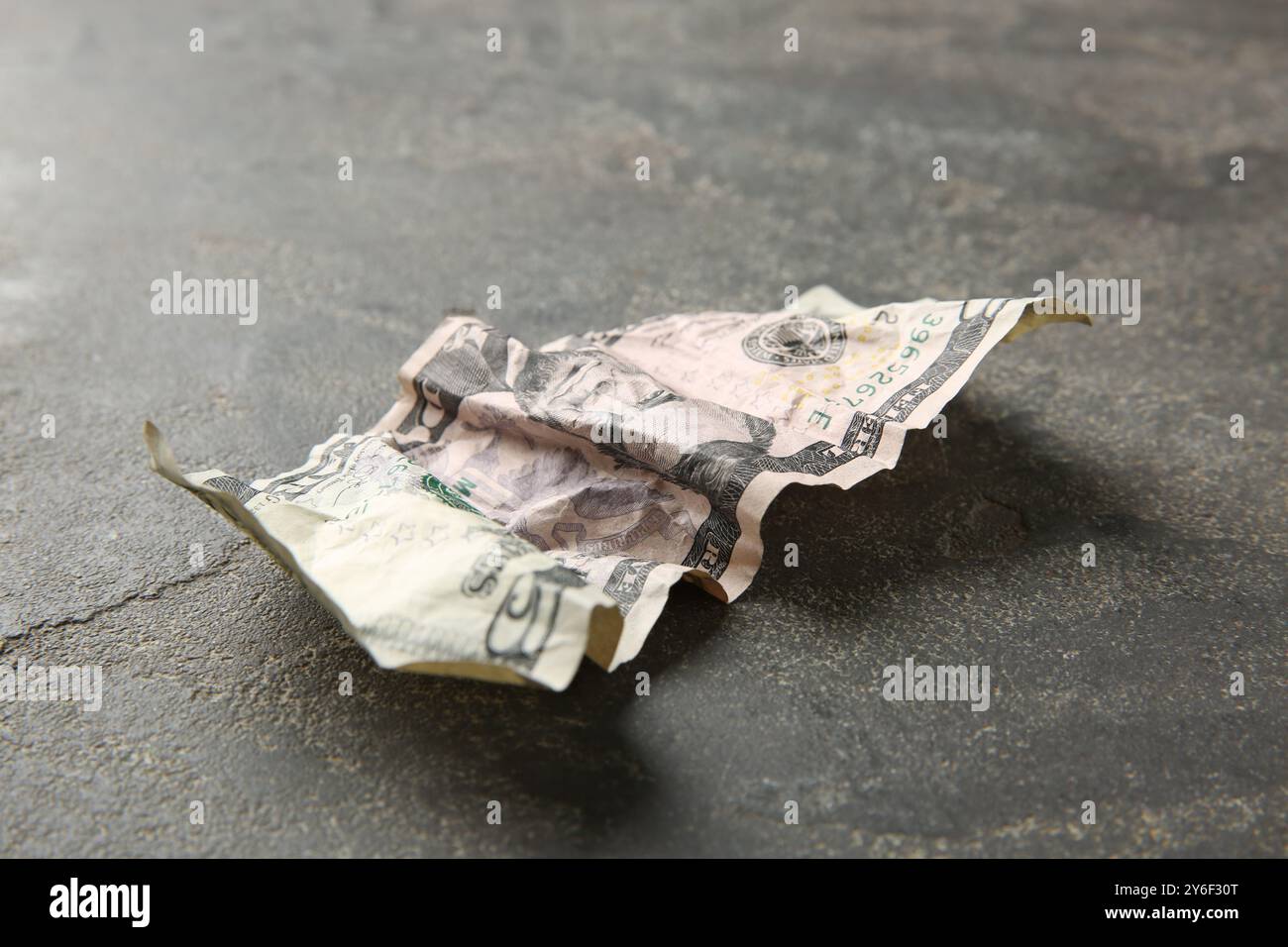 One crumpled dollar banknote on grey table, closeup Stock Photo - Alamy