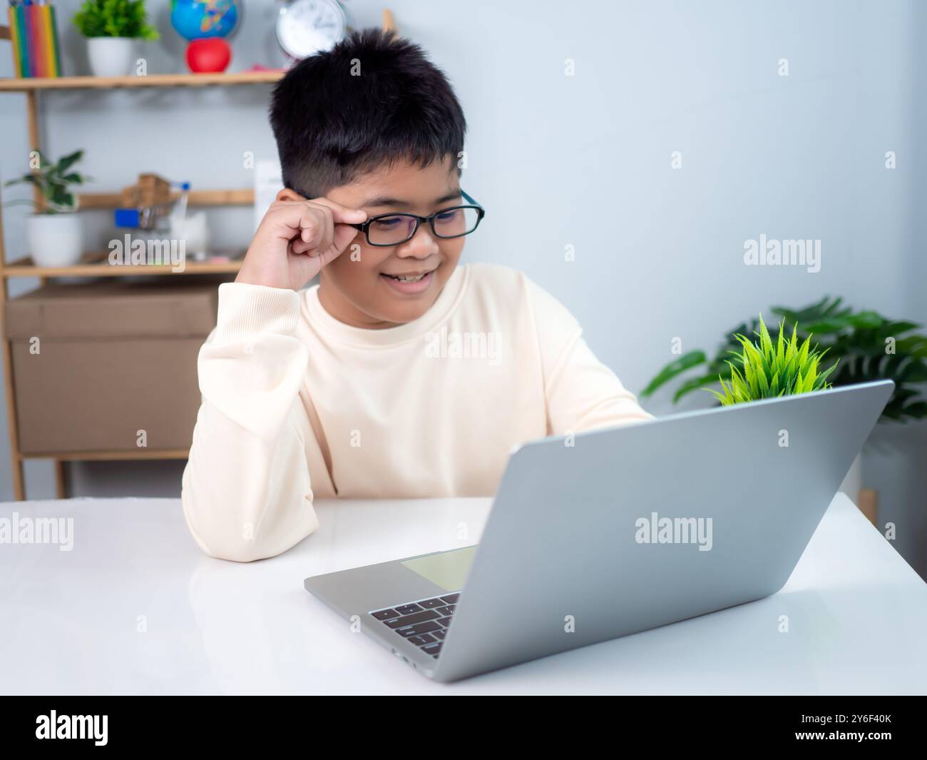 Asian boy student using computer laptop learning. Educational of tech ...