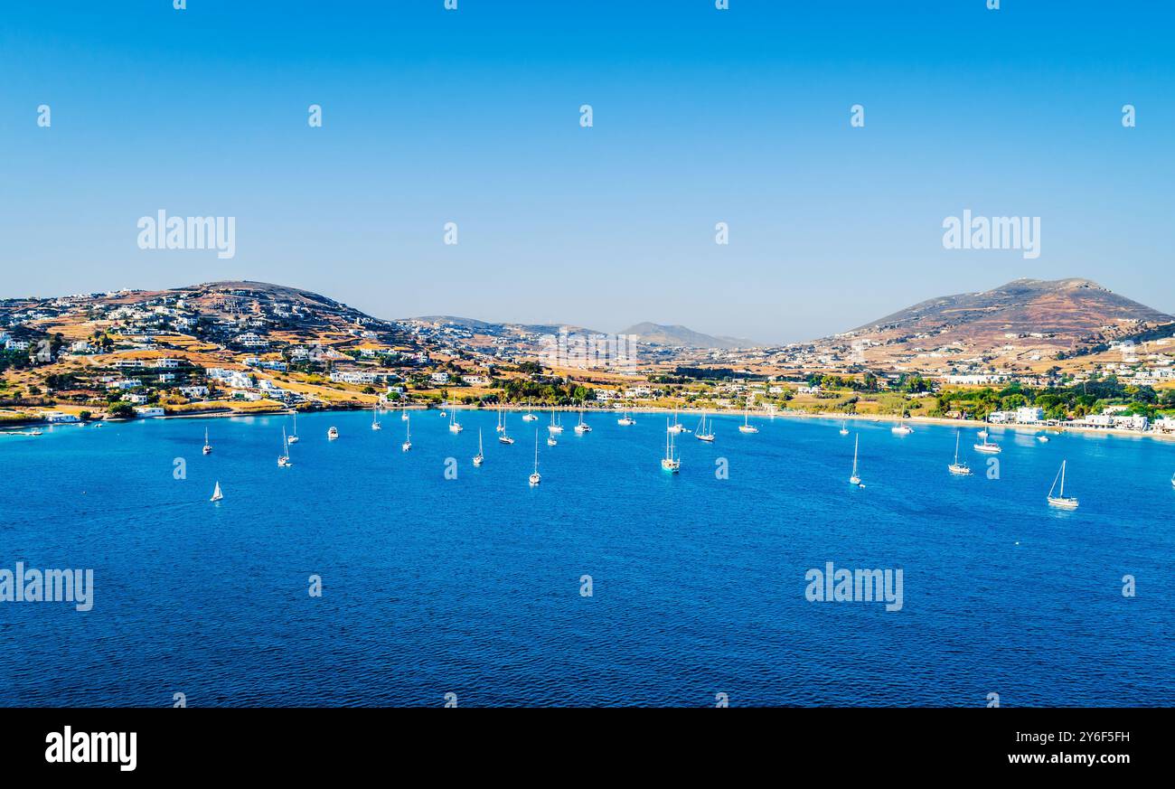 Aerial view of the white sailboats floating in the clear blue sea water ...