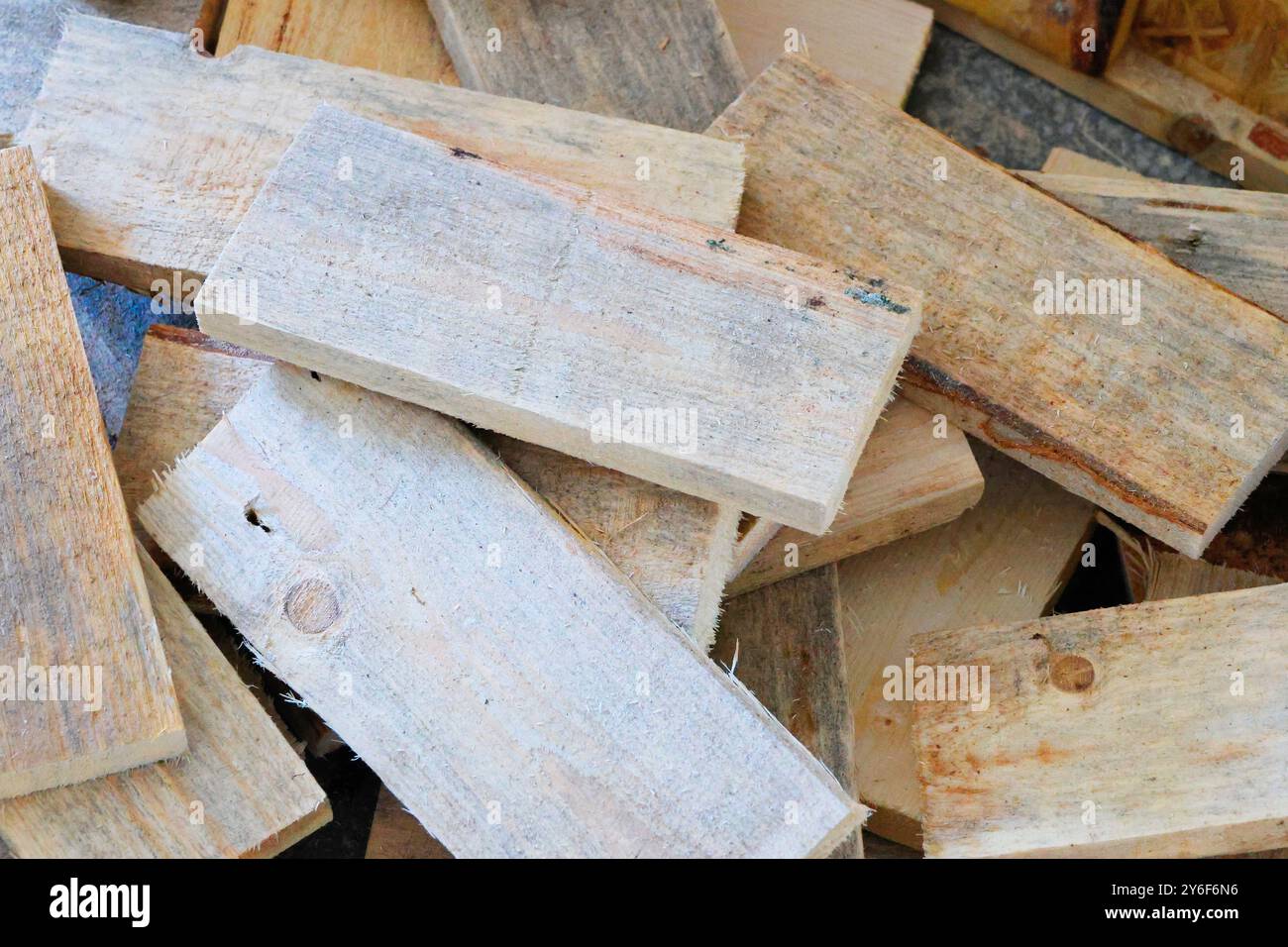 A collection of wooden planks is scattered across a surface, showcasing ...