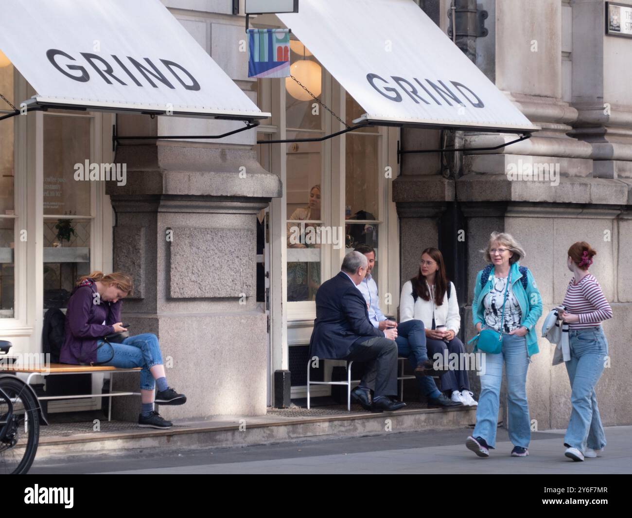 City workers sitting outside Grind Coffee shop Royal Exchange ...