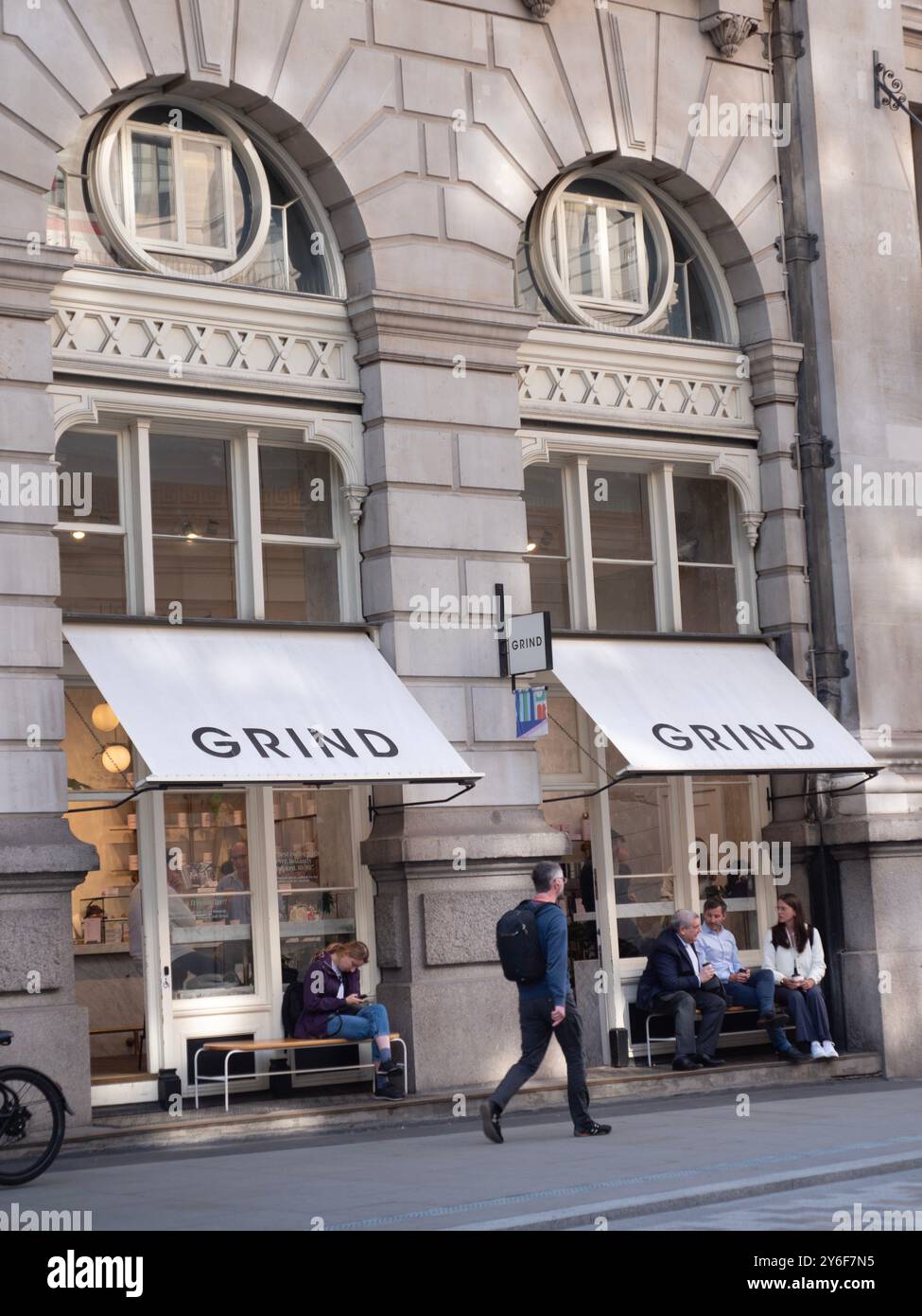 City workers sitting outside Grind Coffee shop Royal Exchange ...
