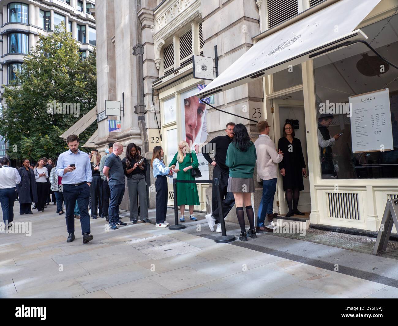 Queues of people queue outside, The Salad Kitchen for take away lunch, as people return to work ...